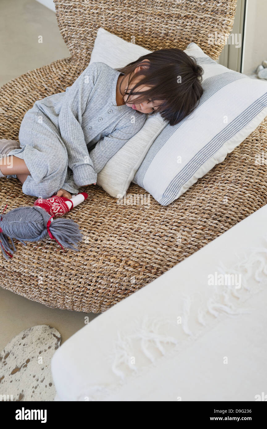 Girl sleeping on a wicker chair Stock Photo - Alamy