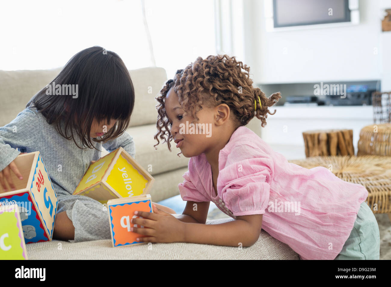 Two girls playing with number blocks Stock Photo - Alamy