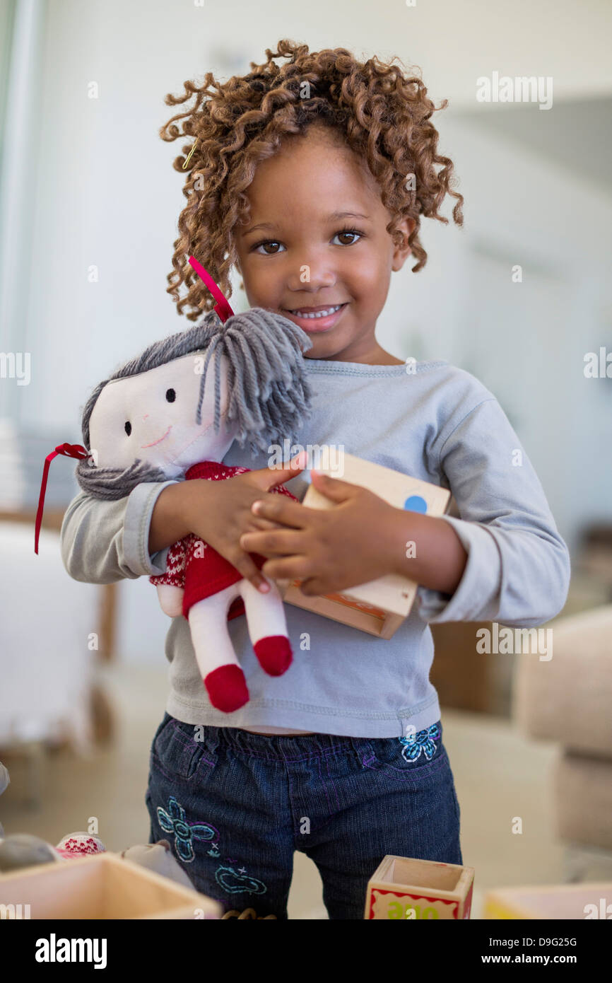 Portrait of a girl holding a rag doll Stock Photo - Alamy