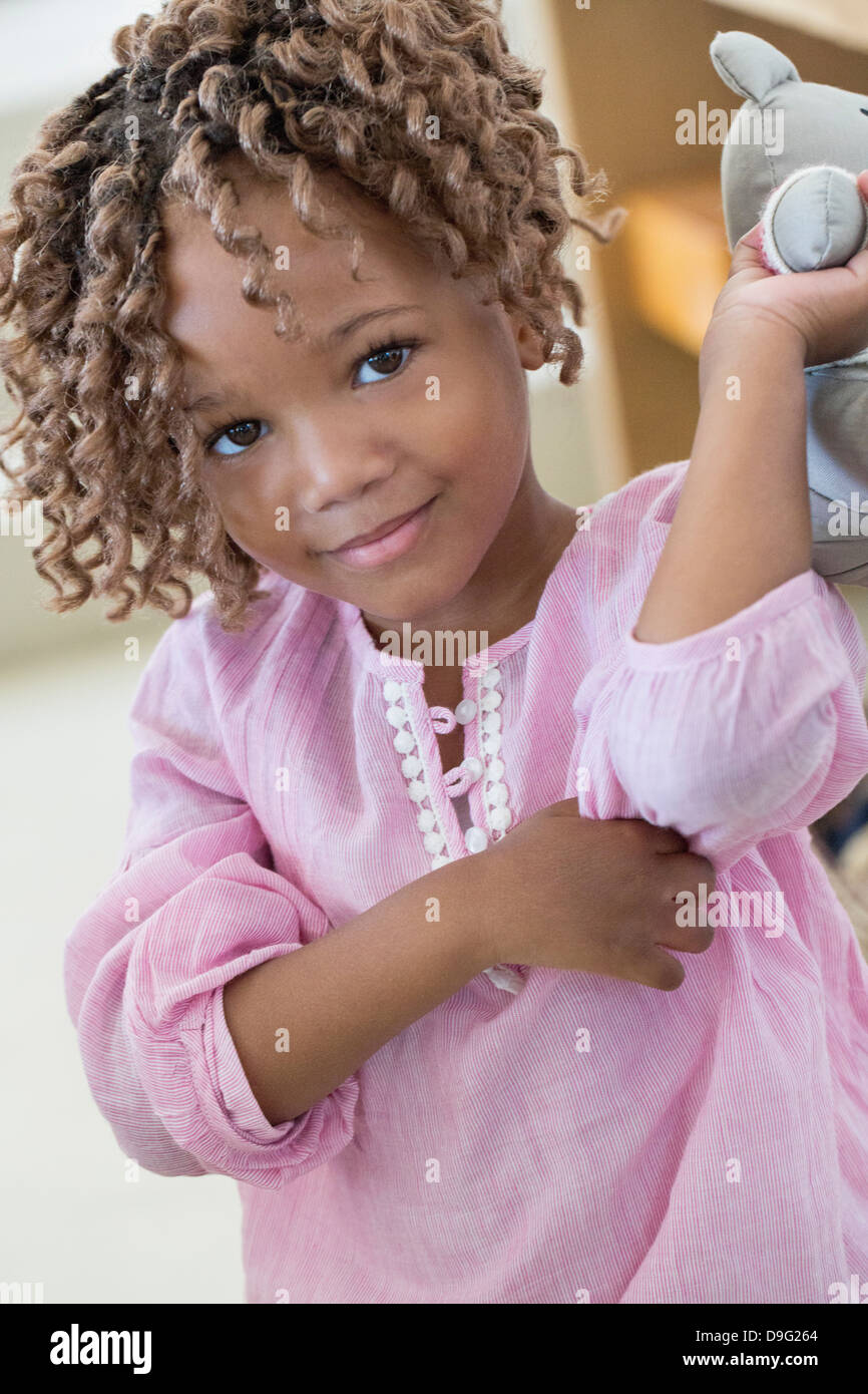 Portrait of a girl holding a rag doll Stock Photo - Alamy