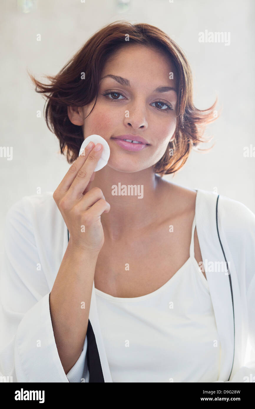 Woman cleaning her face with a cotton pad Stock Photo - Alamy