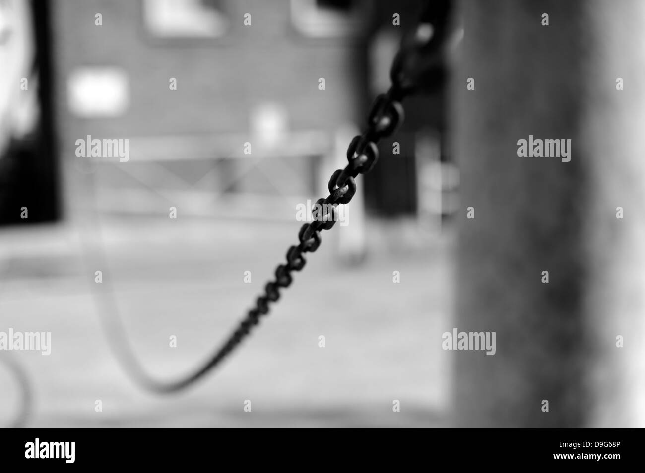 Metal chain blocking a road entrance Stock Photo - Alamy