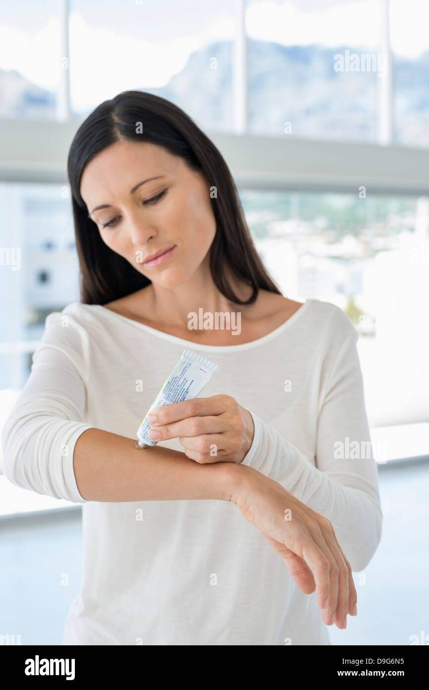 Woman applying ointment on her hand Stock Photo - Alamy