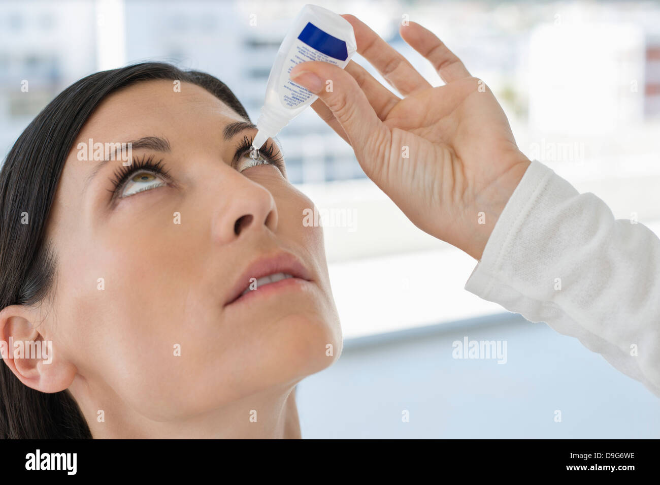 Woman applying eye drops into eye Stock Photo - Alamy