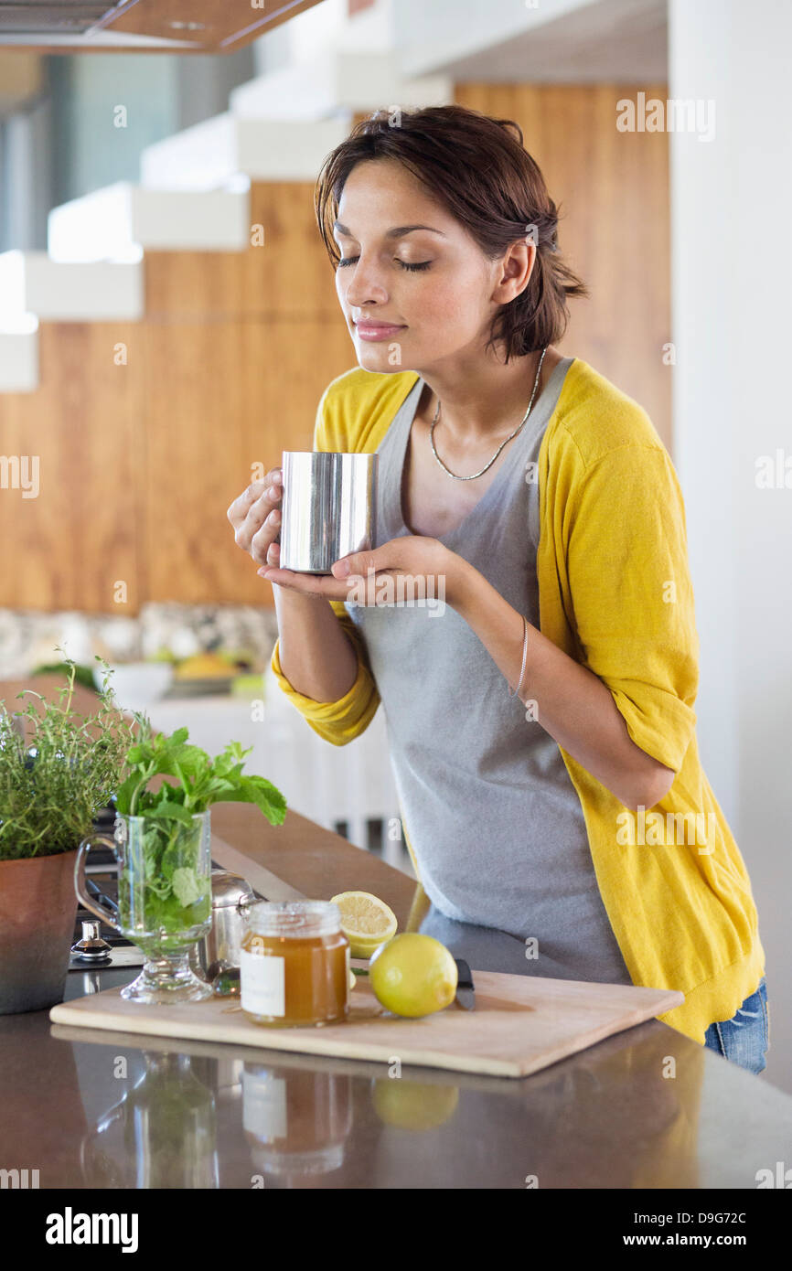 Woman smelling herbal tea Stock Photo - Alamy