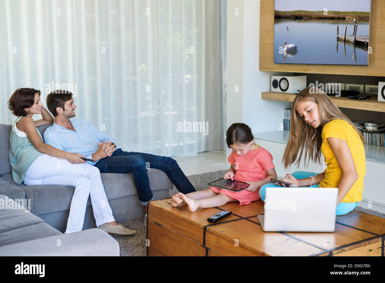Family using electronics gadgets Stock Photo - Alamy