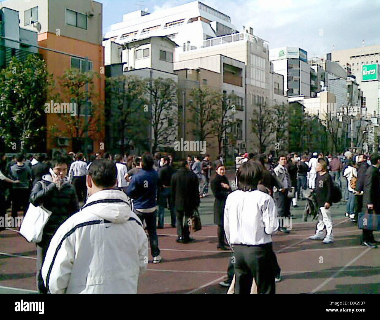 People take refuge at a park in Tokyo's Shimbashi area, after a ...