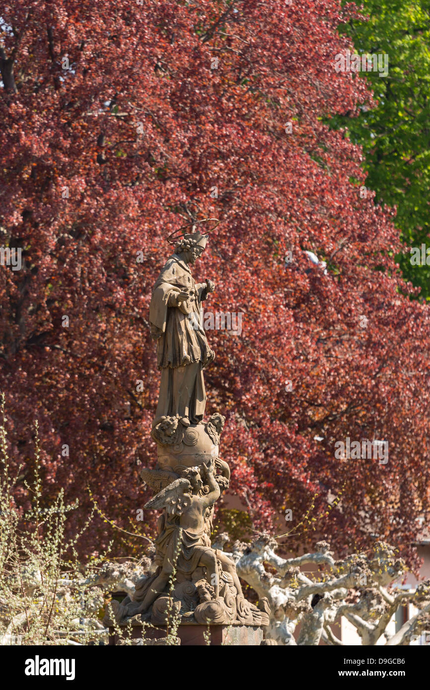 Statue of Saint John of Nepomuk by old bridge leading to ancient town ...