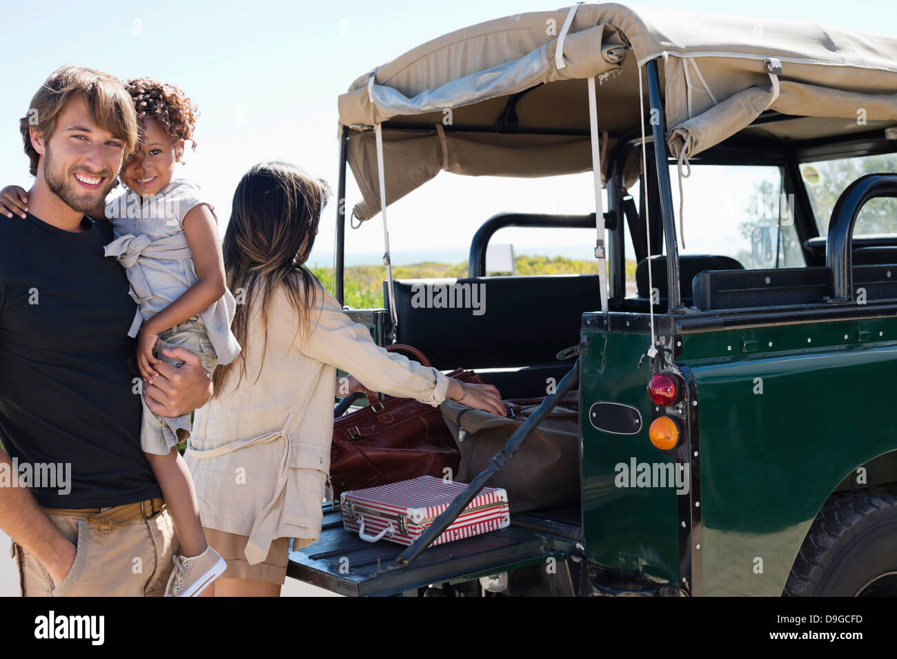 Happy family beside a SUV Stock Photo - Alamy