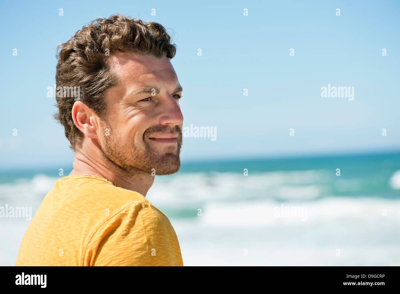 Man smiling on the beach Stock Photo - Alamy
