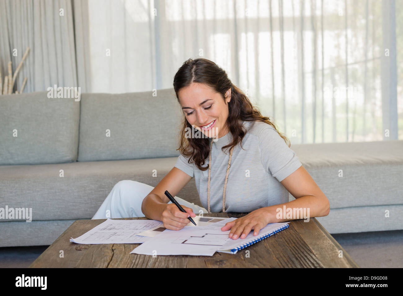 Woman doing paperwork at home Stock Photo - Alamy