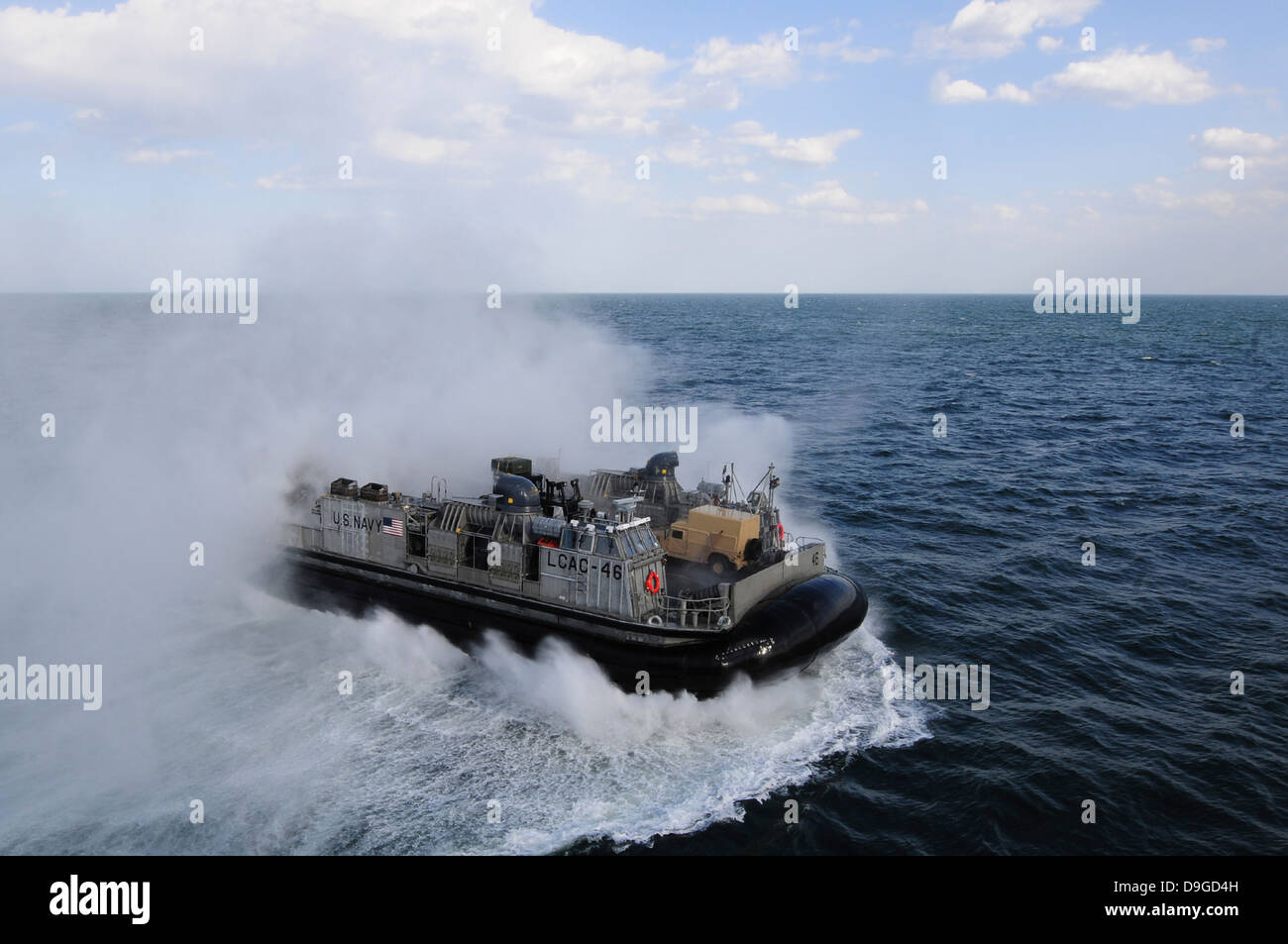 A landing craft utility from Assault Craft Unit 2 transits at high ...