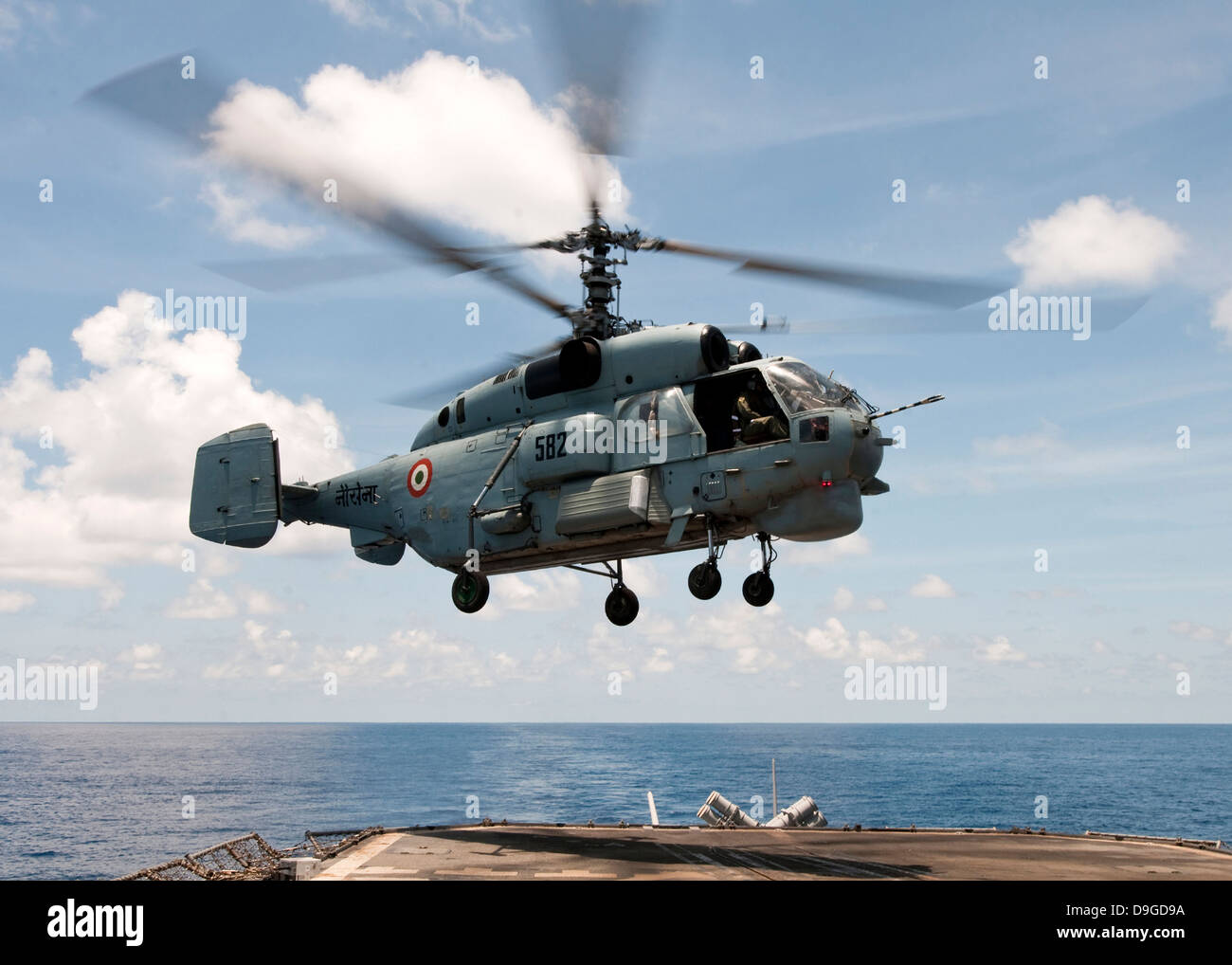 An Indian Navy Kamov Ka-31 lands on the flight deck of USS Bunker Hill ...