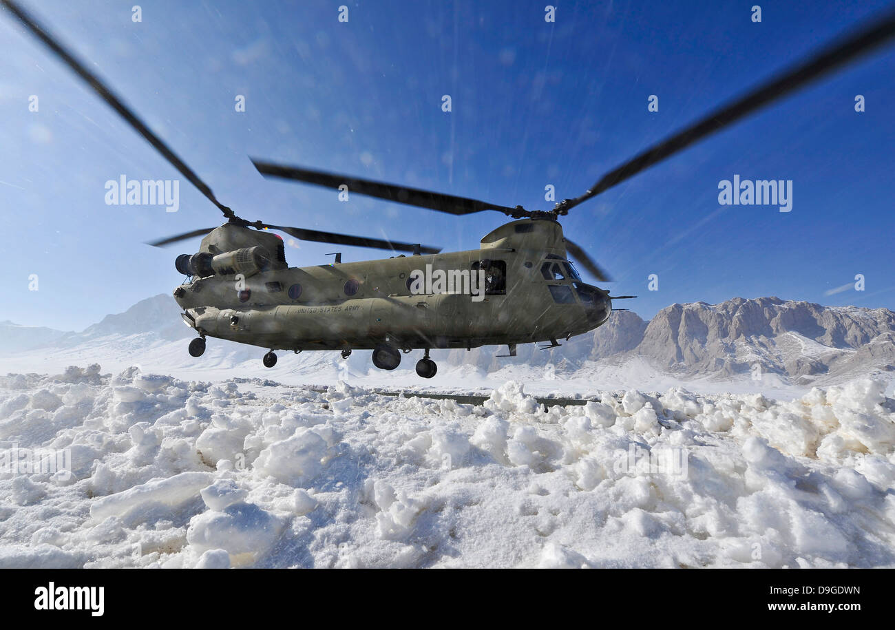 Snow flies up as a U.S. Army CH-47 Chinook helicopter prepares to land ...