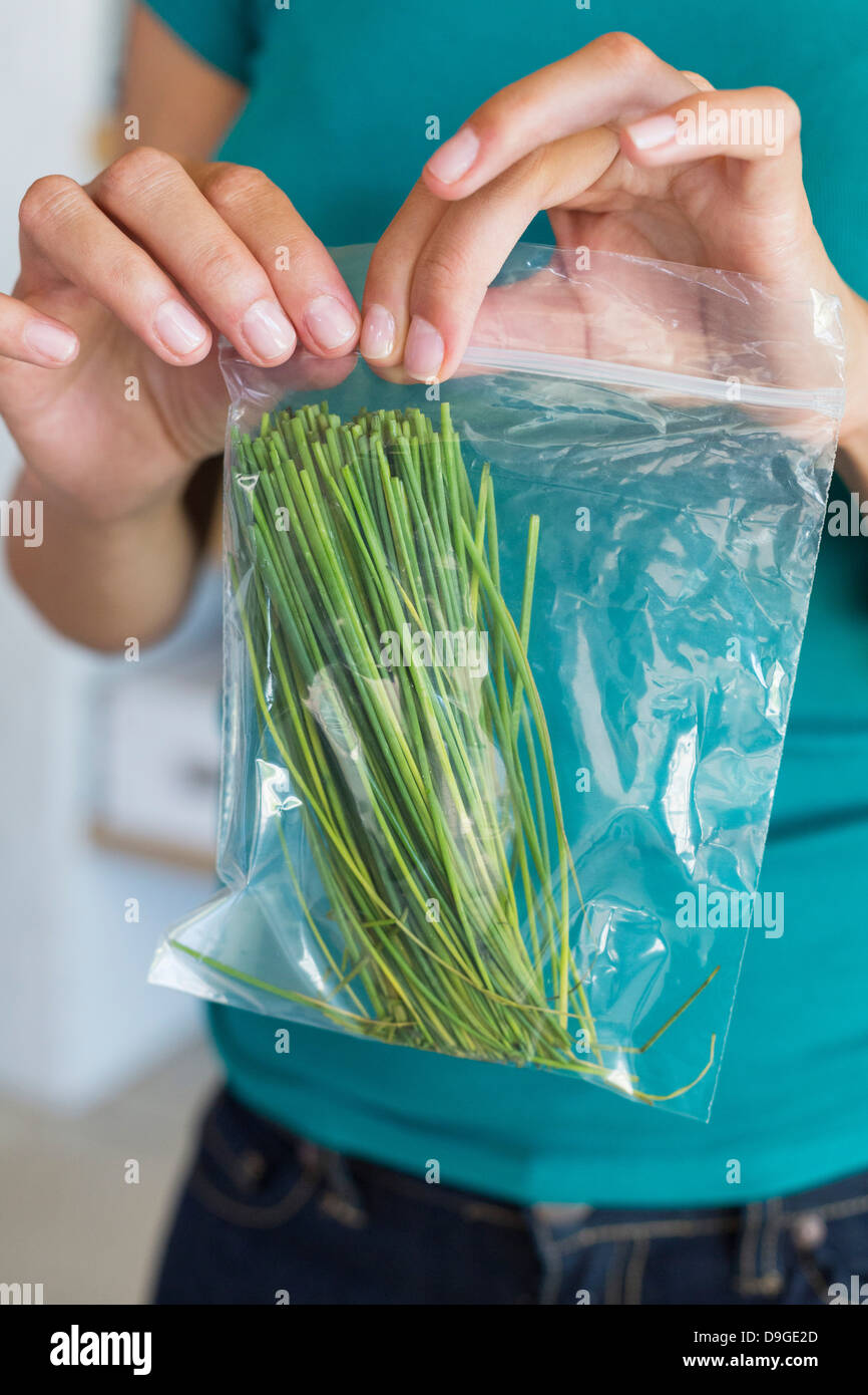 Woman packing leaf vegetables for storage Stock Photo - Alamy