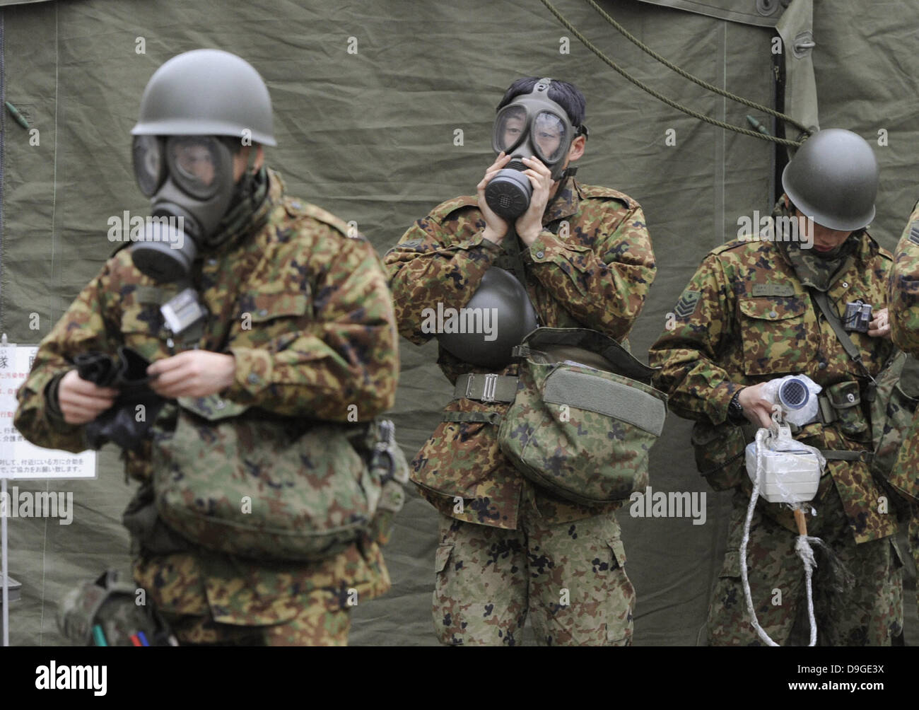 Members of the Japan Self-Defense Forces wearing protective gear get ...