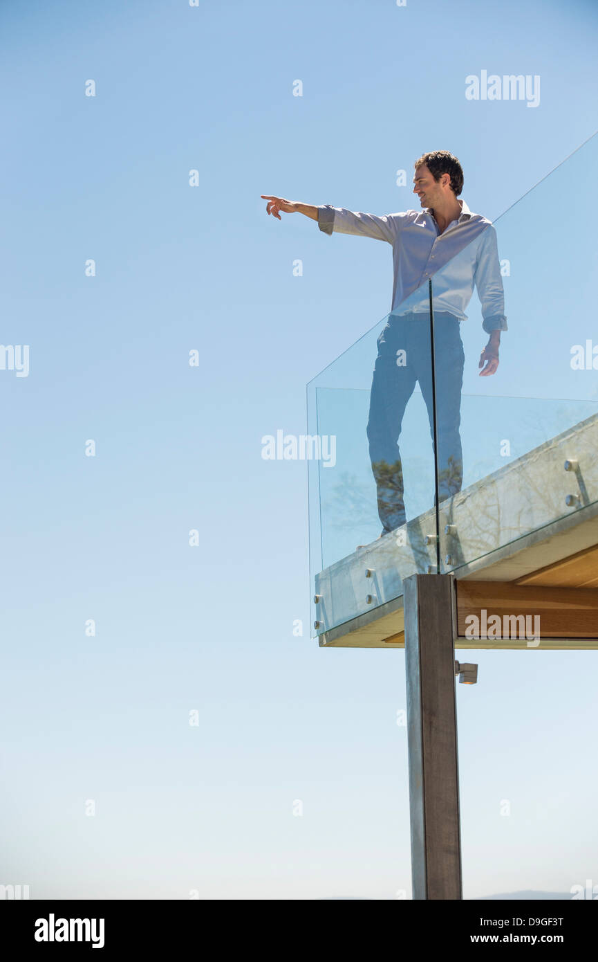 Man standing on the terrace and pointing Stock Photo - Alamy