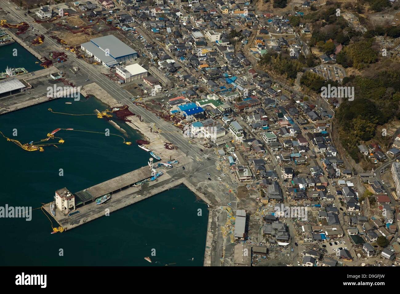 Fishing vessels remain capsized in the port of Otsu, Ibaraki prefecture ...