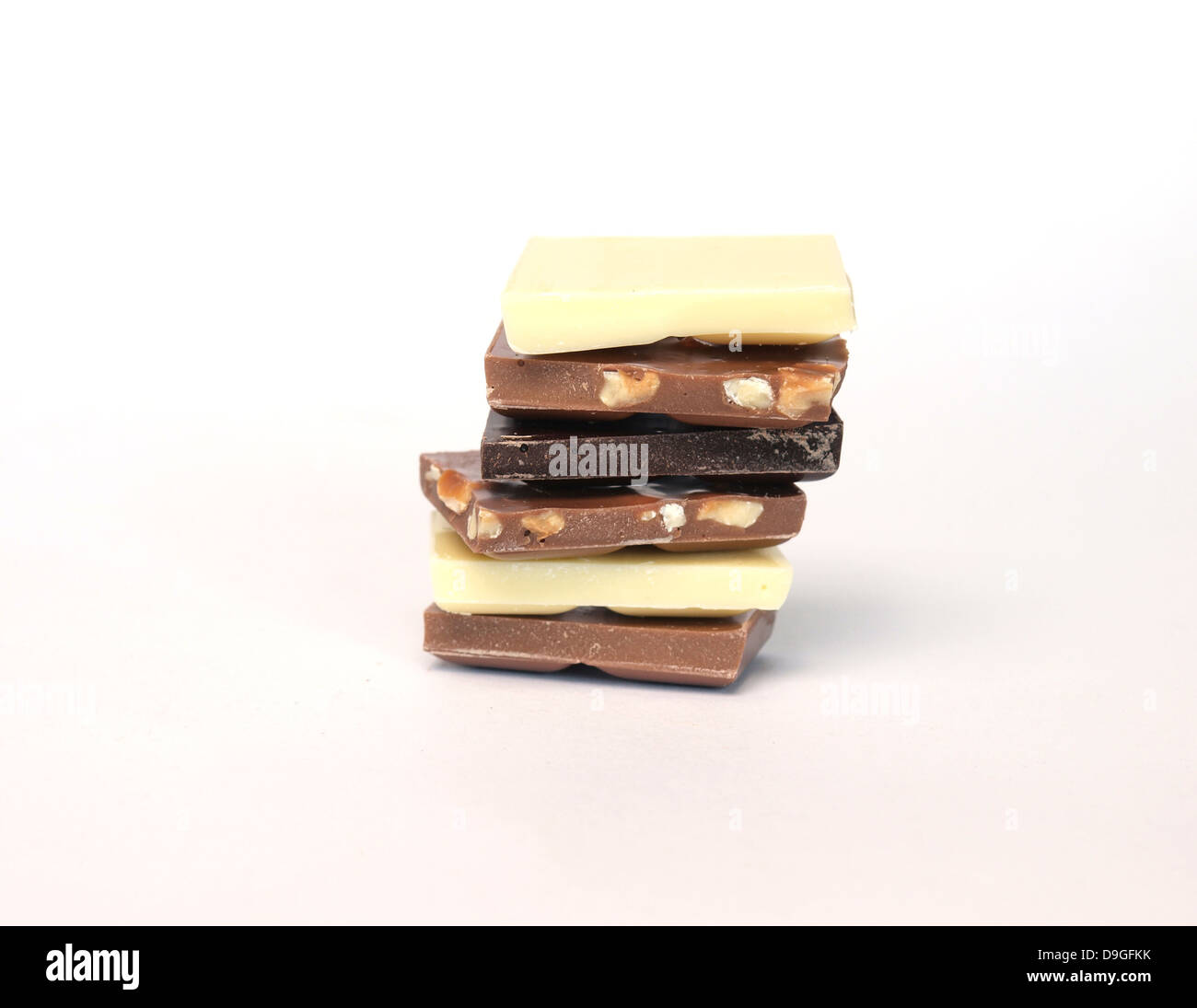 Different chocolate pieces on a bright background Stock Photo - Alamy