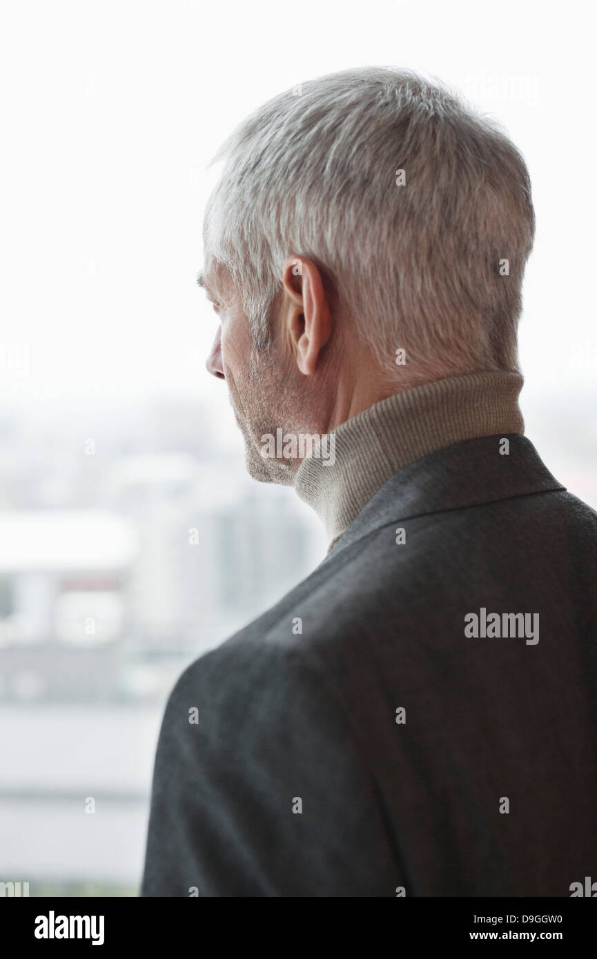 Man looking through a window Stock Photo - Alamy