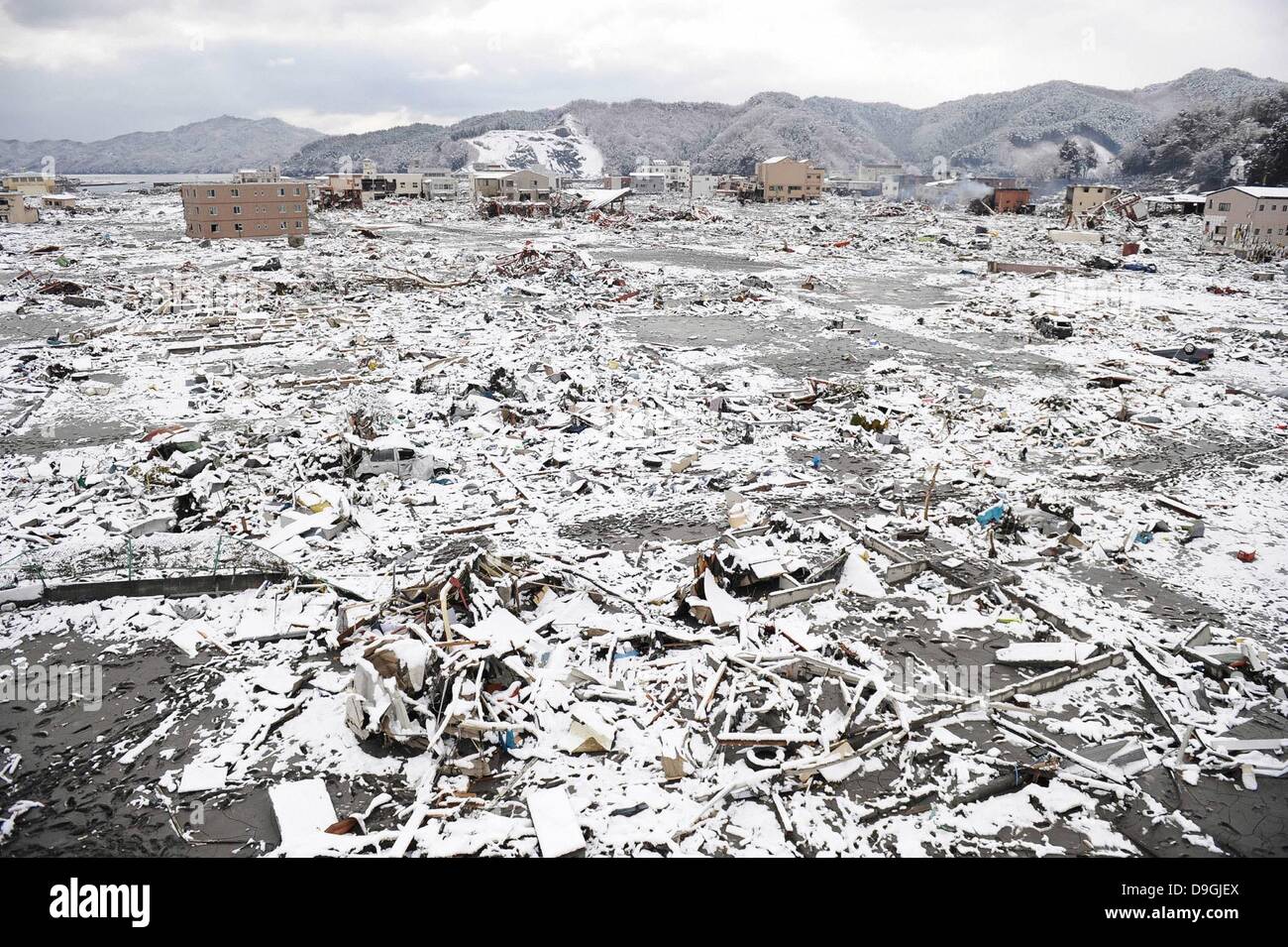 Snow covers the tsunami-damaged remains of the town of Okushi in Iwate ...