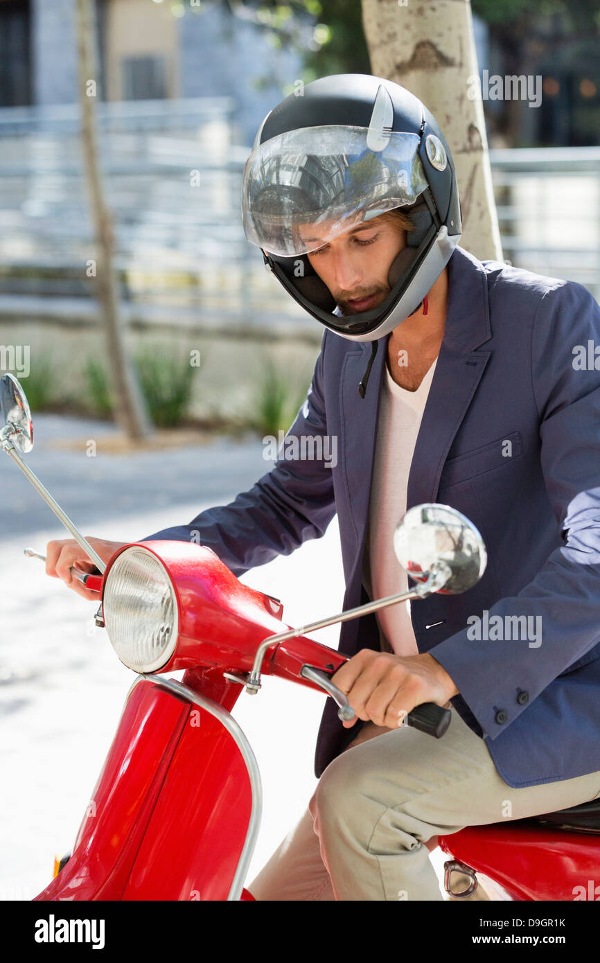 Man riding a scooter Stock Photo - Alamy