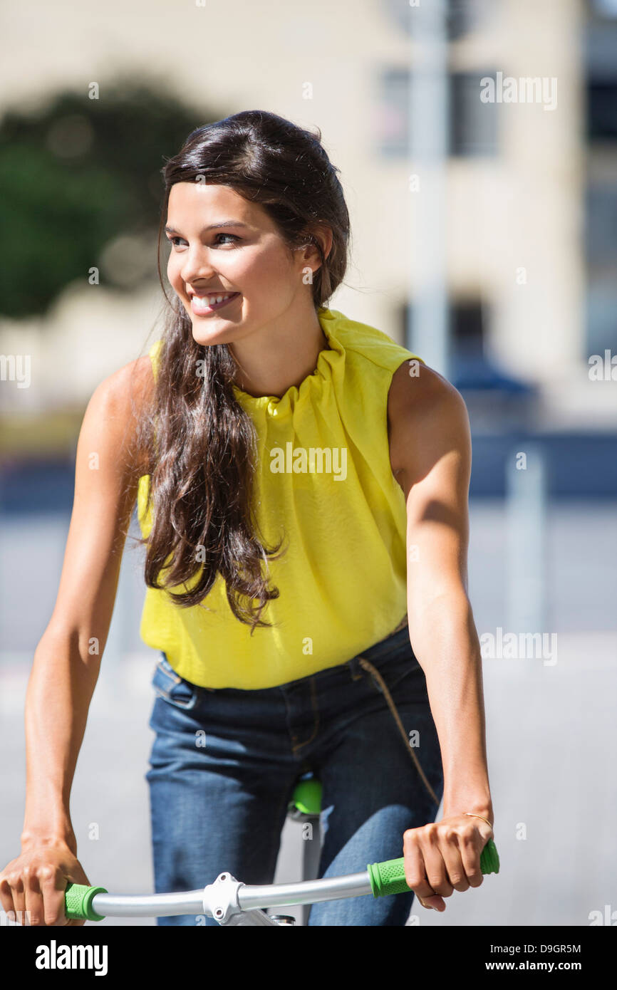 Woman riding a bicycle and smiling Stock Photo - Alamy