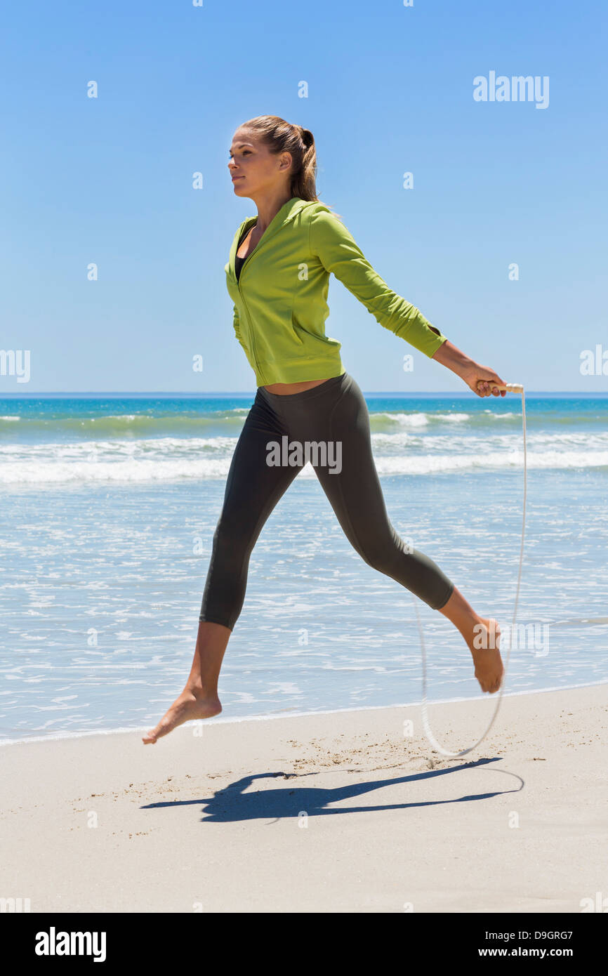 Woman skipping at the beach hi-res stock photography and images - Alamy
