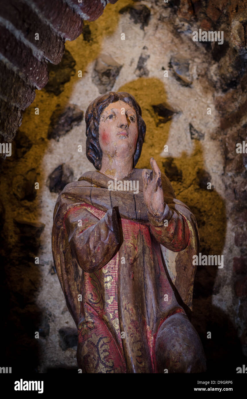 Praying old wooden religious statue Stock Photo - Alamy