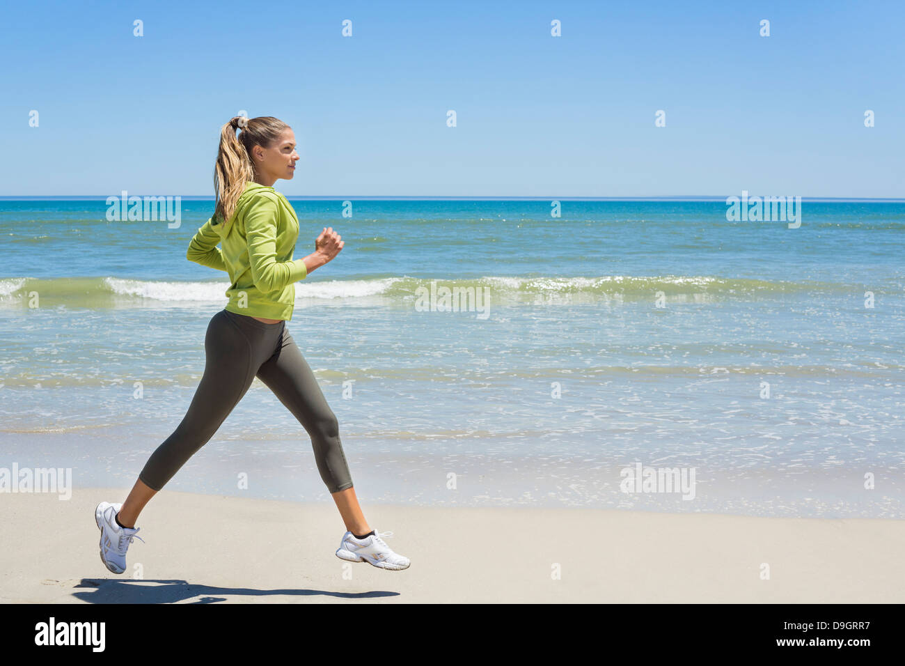 Woman jogging on the beach Stock Photo - Alamy