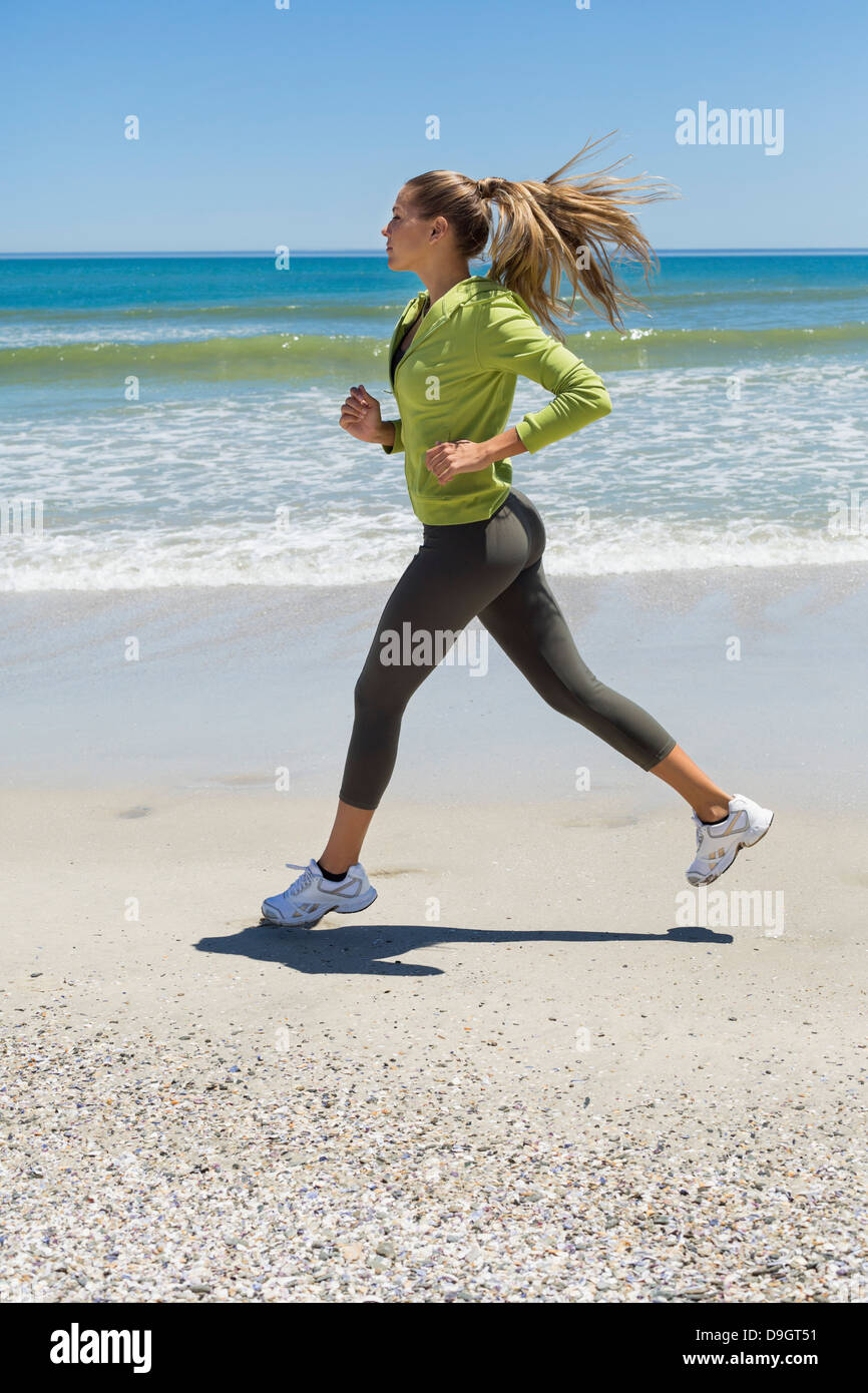 Woman jogging on the beach Stock Photo - Alamy