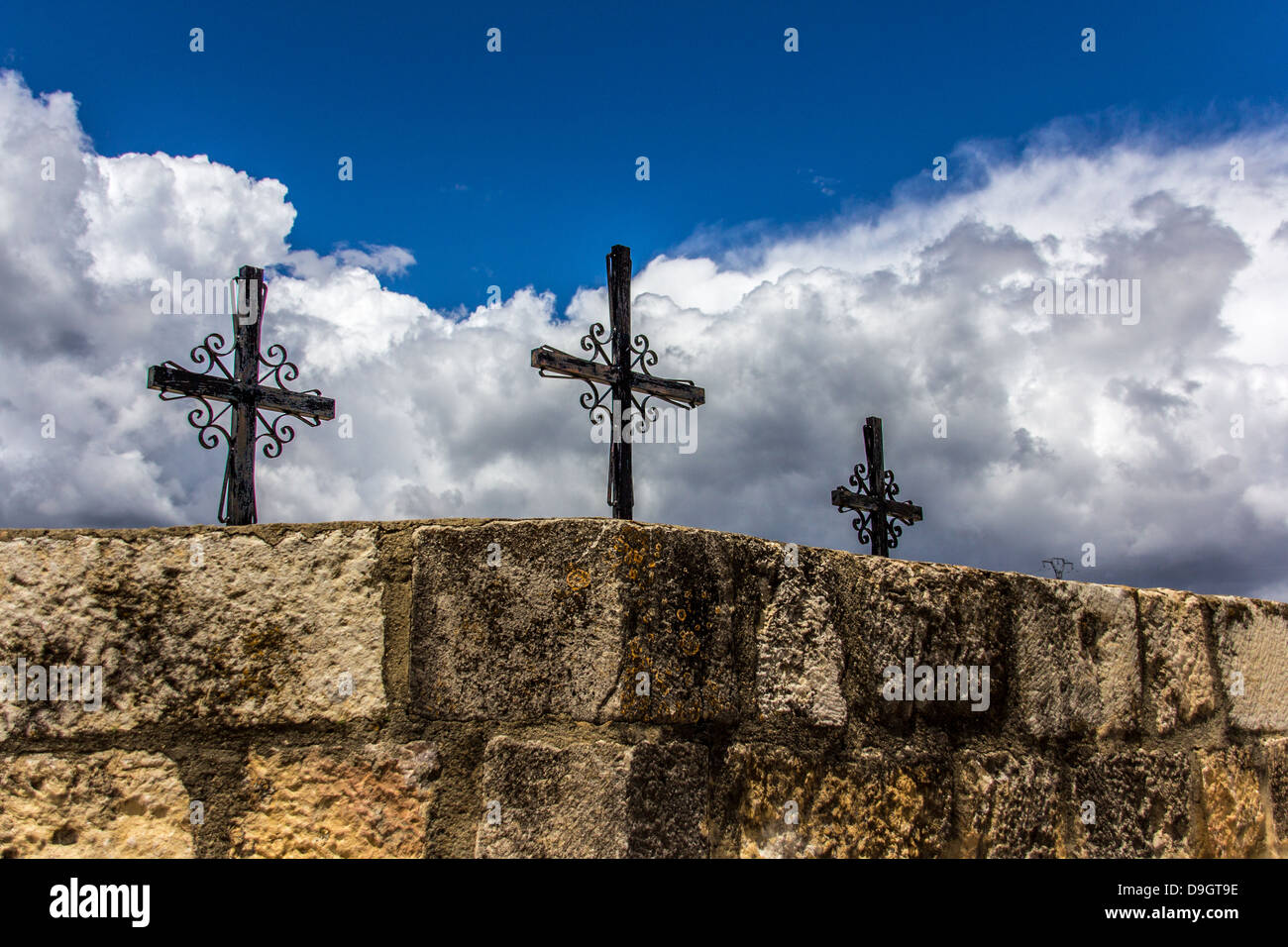 3 small metal Crosses on a wall in Spain Stock Photo - Alamy