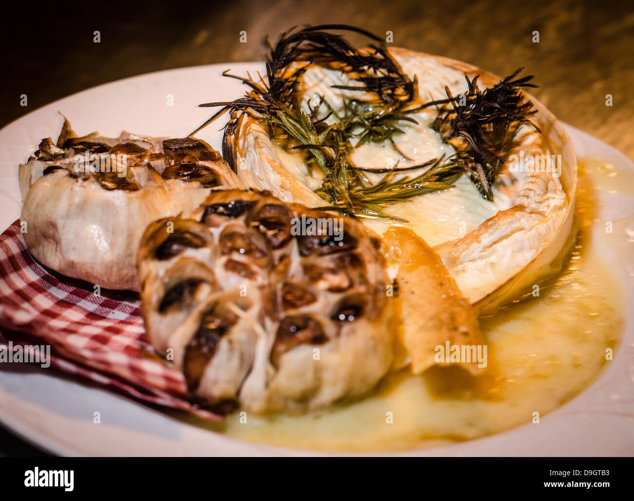 whole Camembert with rosemary and garlic Stock Photo - Alamy