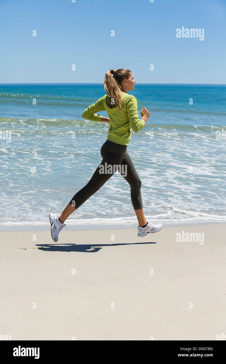 Woman jogging on the beach Stock Photo - Alamy