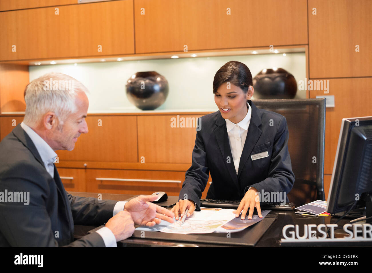 Young female hotel receptionist hi-res stock photography and images - Alamy