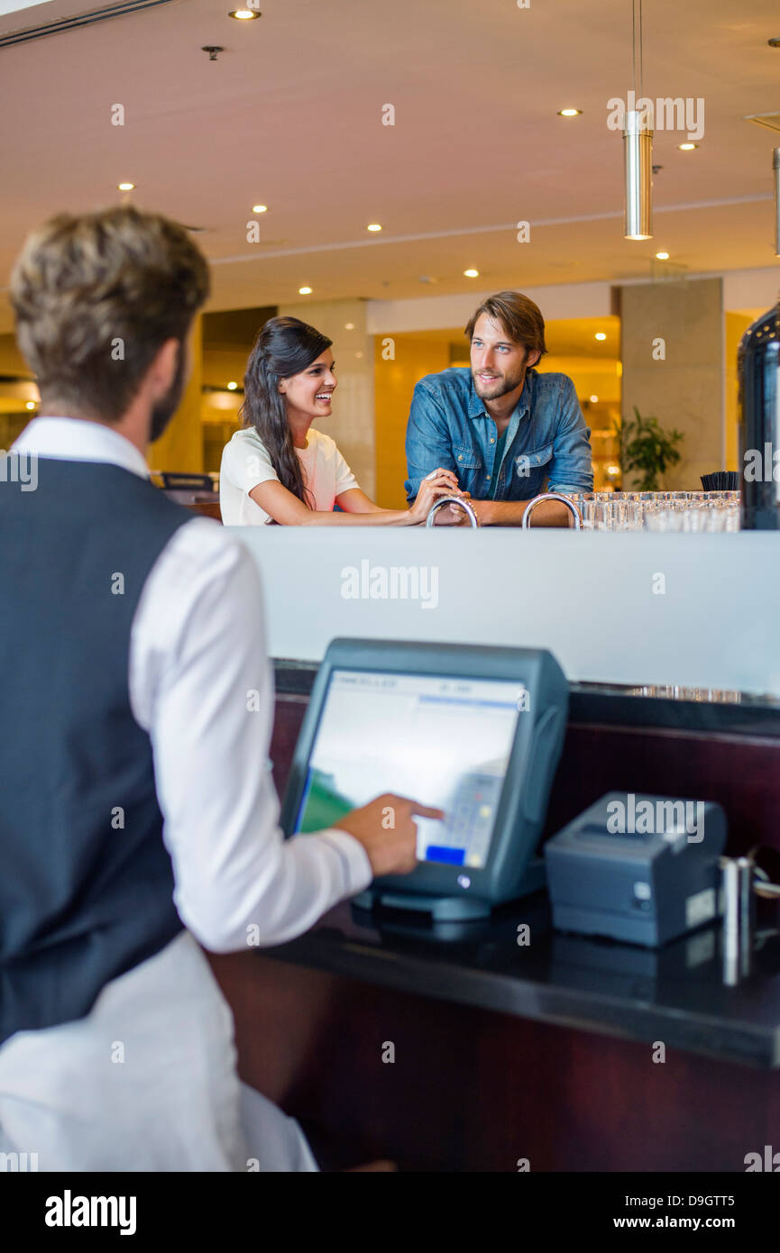 Couple at checkout counter in a restaurant Stock Photo - Alamy
