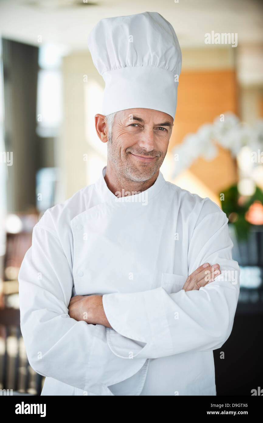 Portrait of a chef smiling with arms crossed Stock Photo - Alamy