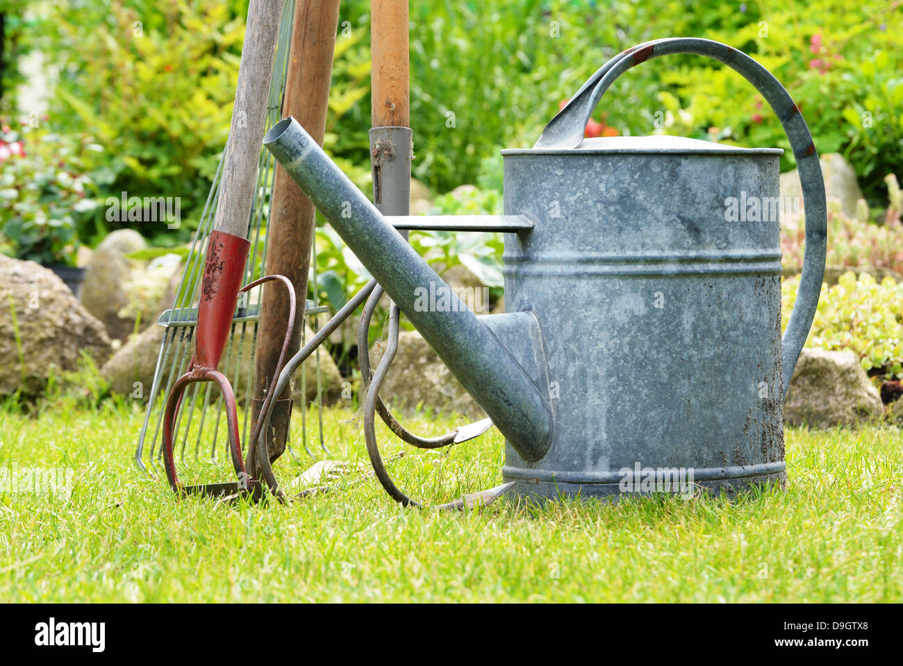 Watering can and garden tools Stock Photo - Alamy