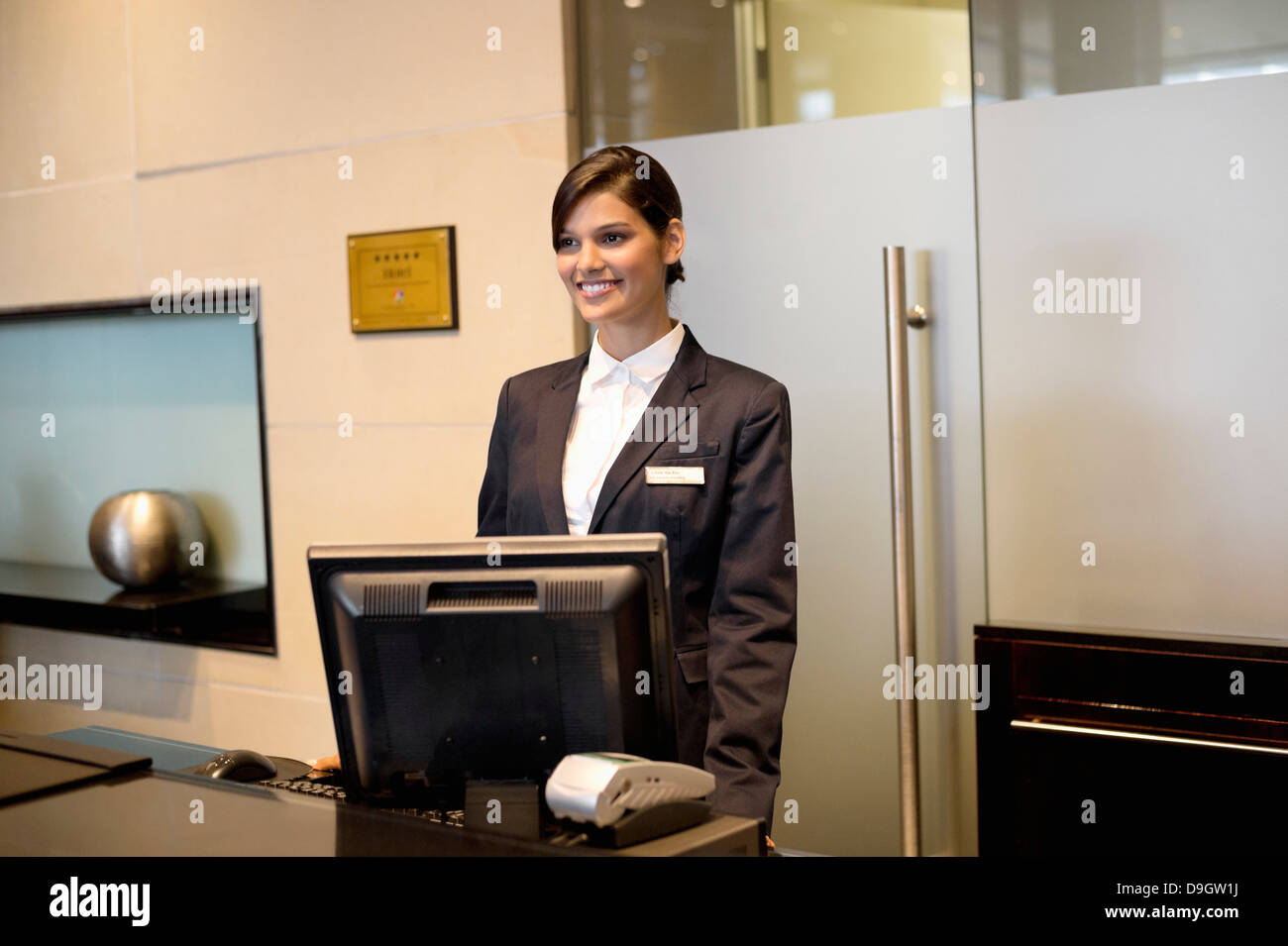 Receptionist woman standing reception desk hi-res stock photography and ...