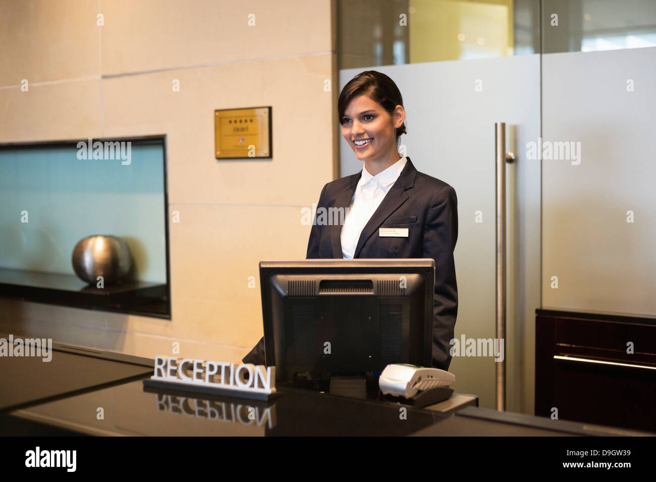 Receptionist woman standing reception desk hi-res stock photography and ...