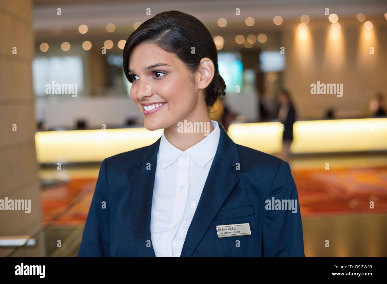 Receptionist smiling in a hotel lobby Stock Photo - Alamy