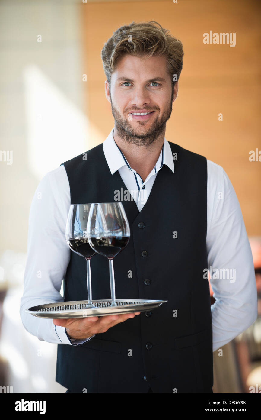 Portrait happy waiter serving hi-res stock photography and images - Alamy