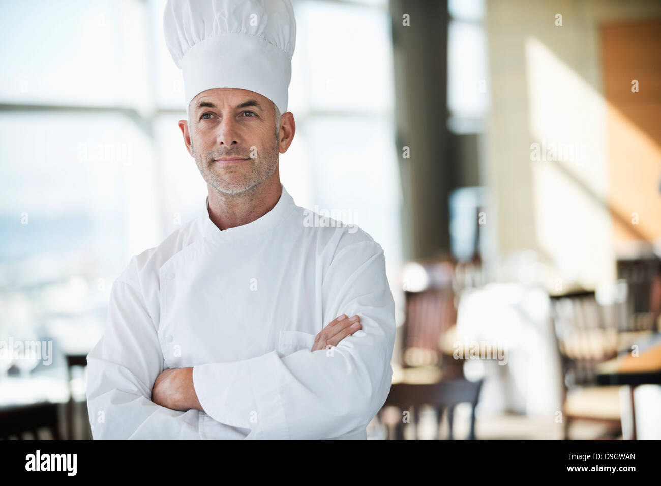 Chef standing with arms crossed in a restaurant Stock Photo - Alamy
