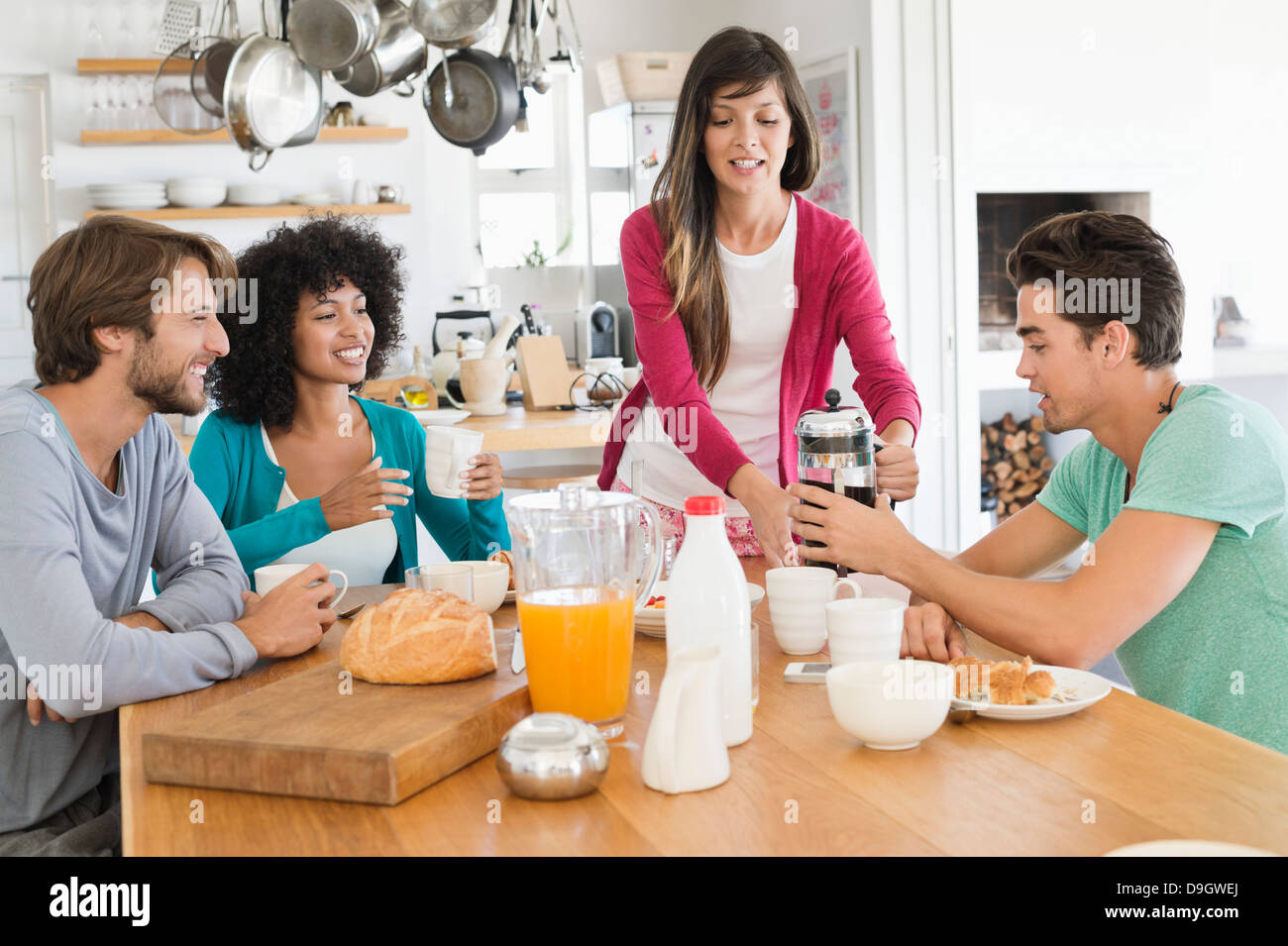 Friends smiling at a dining table Stock Photo - Alamy