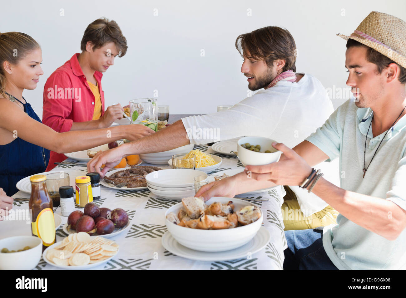 Friends eating lunch at dining table Stock Photo - Alamy
