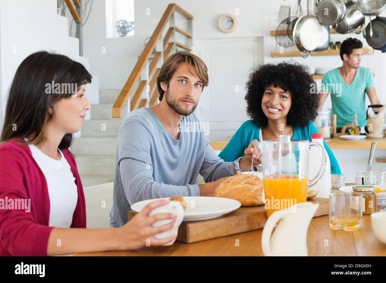Friends at a dining table Stock Photo - Alamy