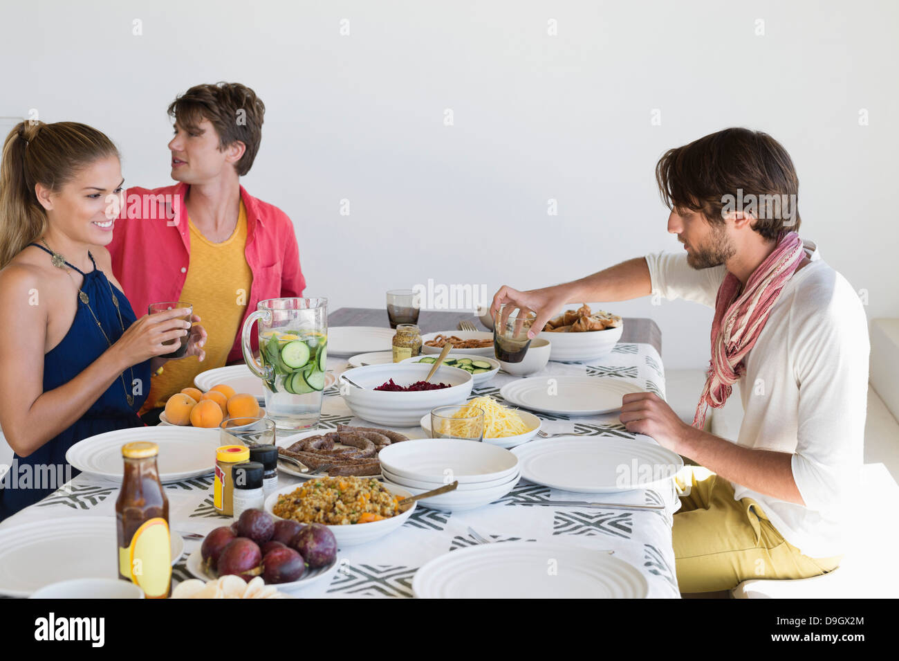 Friends eating lunch at dining table Stock Photo - Alamy