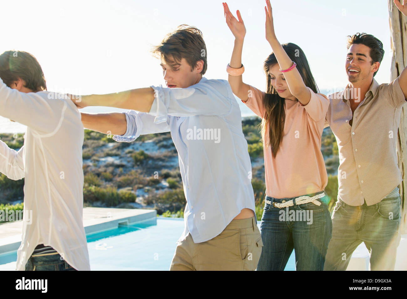 Group of friends dancing at the poolside Stock Photo - Alamy