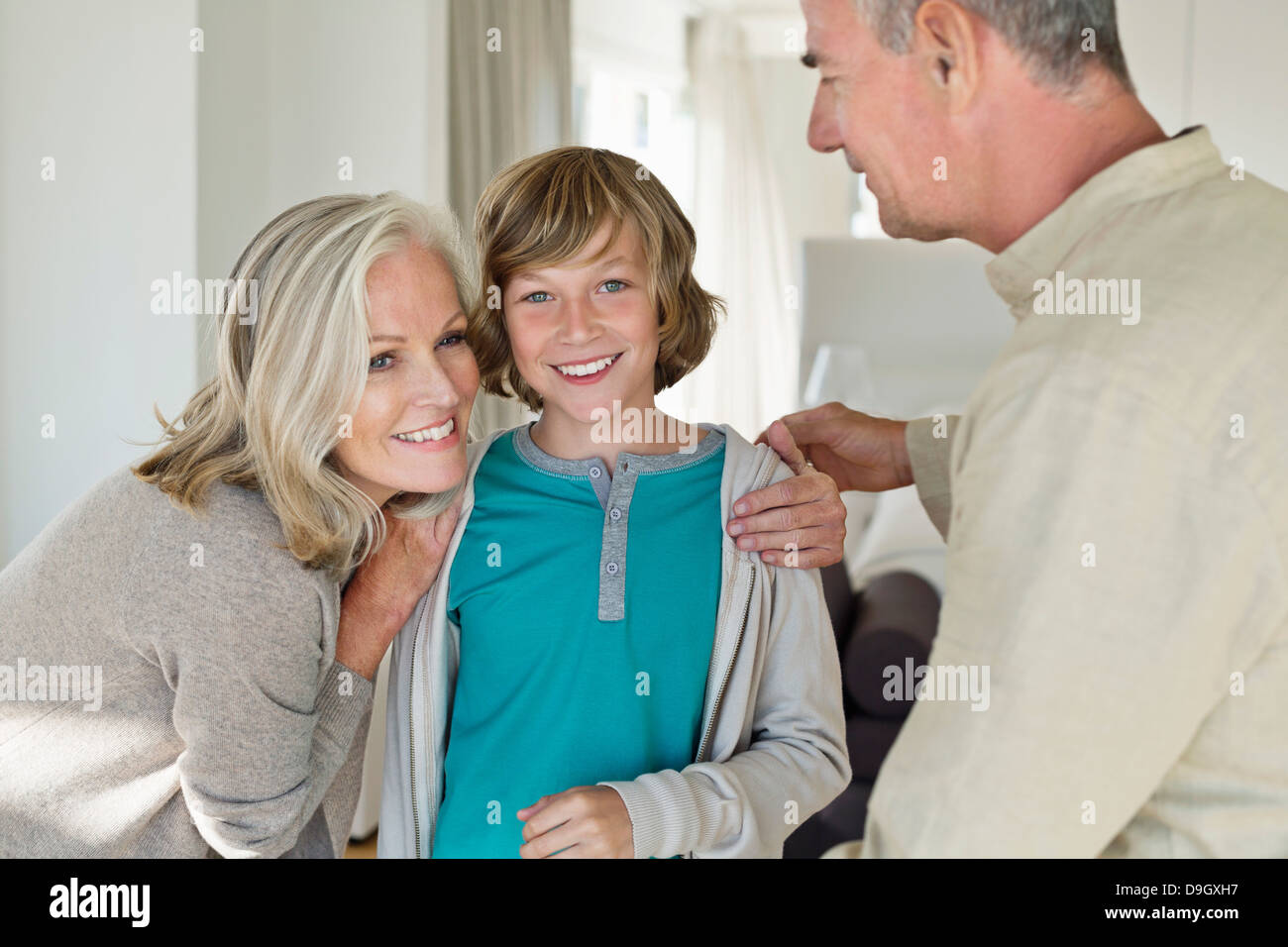 Grandparents hugging their grandson at home Stock Photo - Alamy