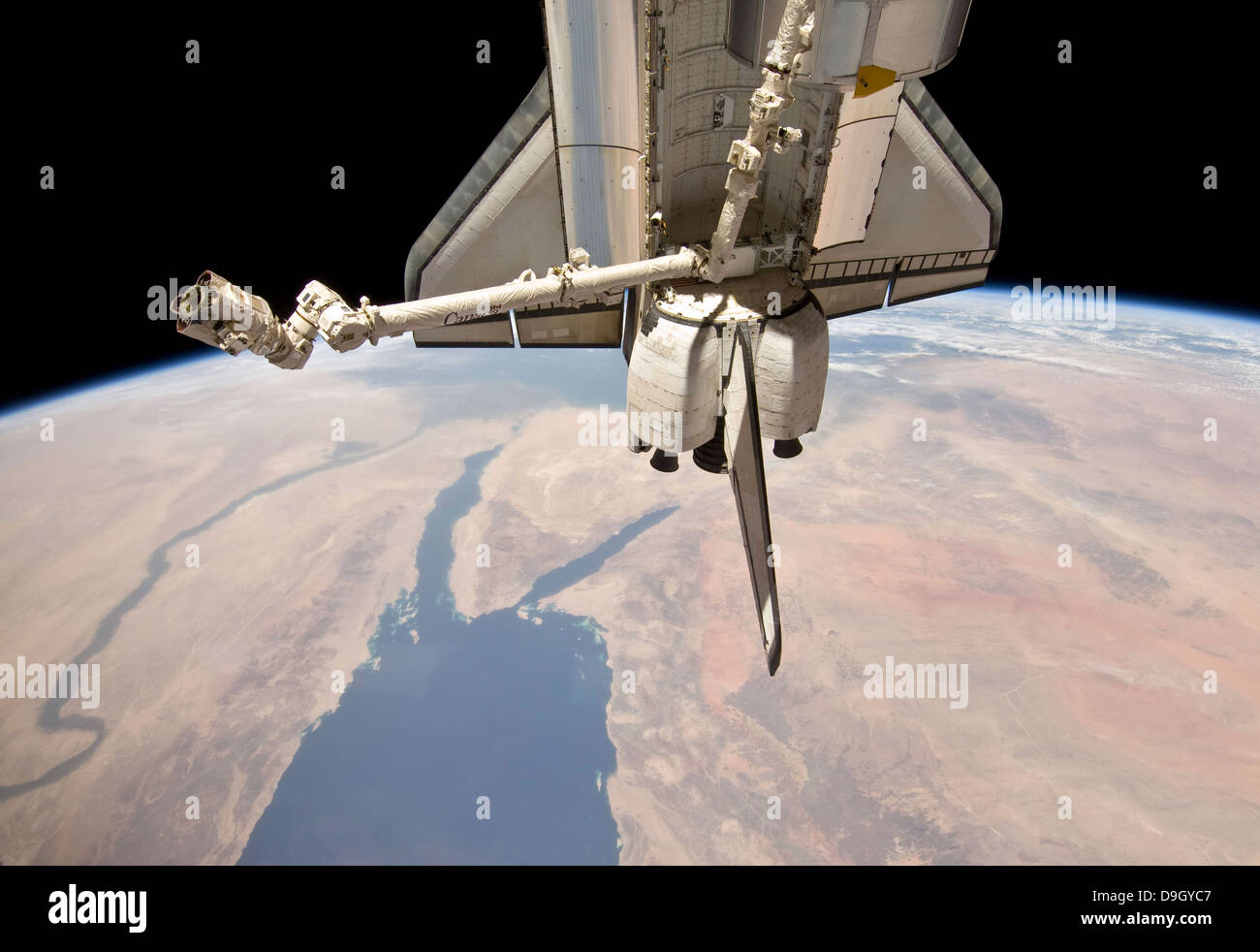 The aft section of the docked space shuttle Discovery and the station's ...